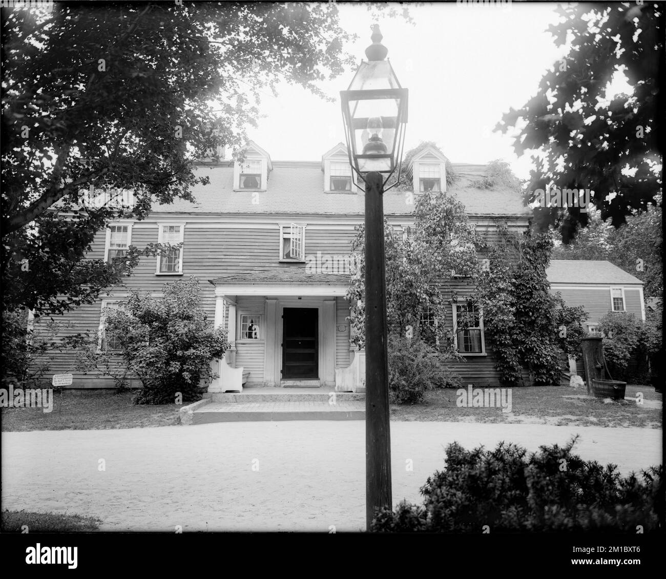 Wayside Inn, Sudbury, Mass. (lamp post and water pump at front of house ...