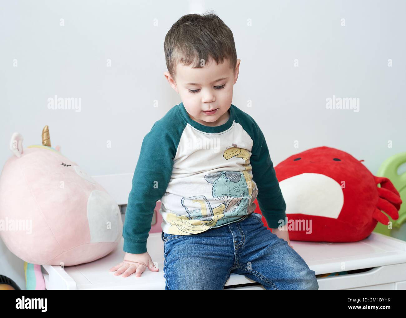 expressive baby boy posing for portraits in his room surrounded by toys ...