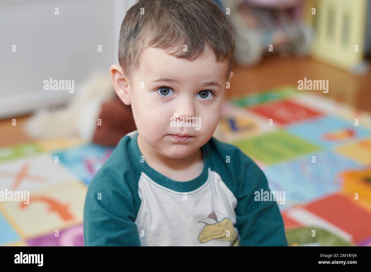 expressive baby boy posing for portraits in his room surrounded by toys ...