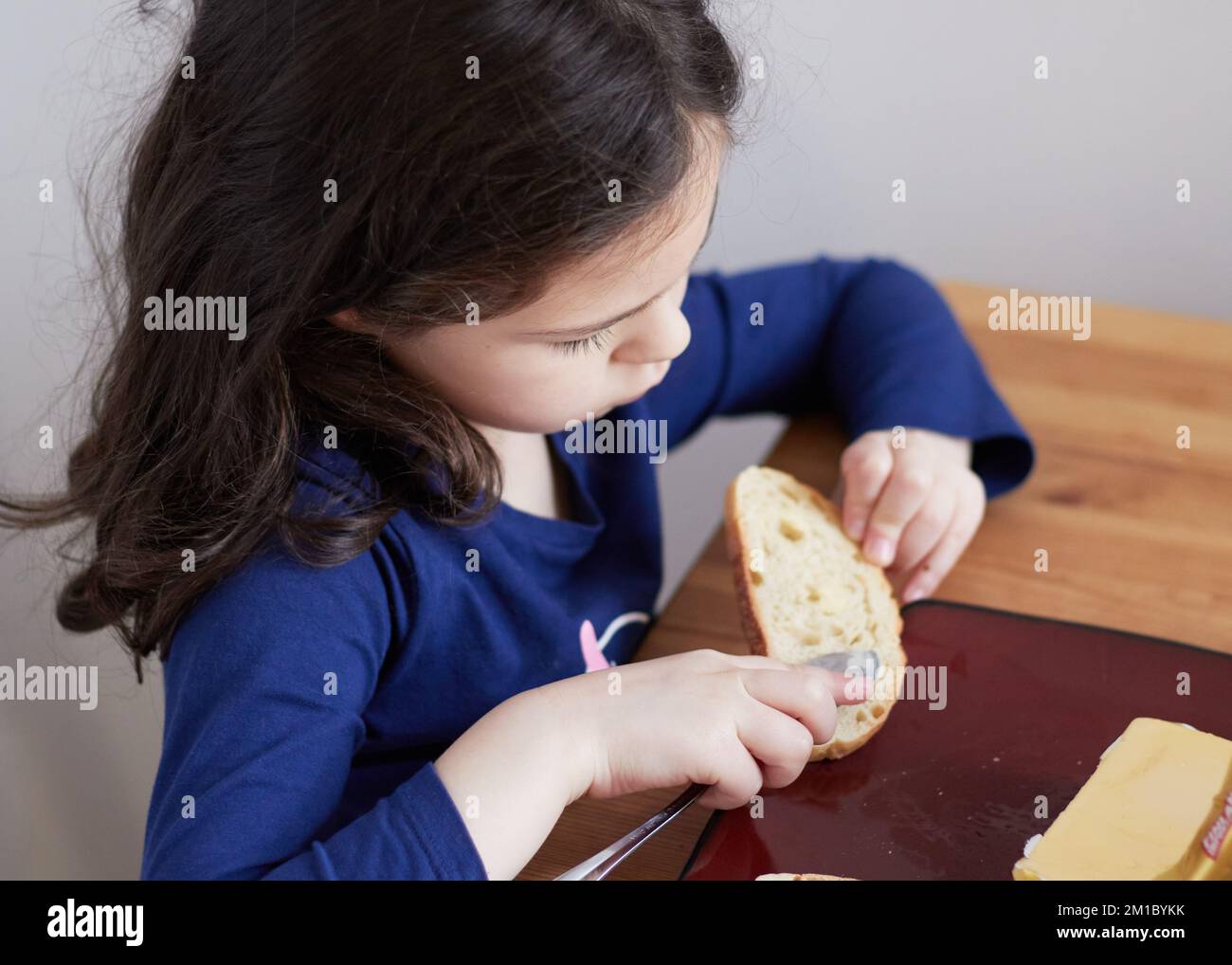 young girl having snacks at home Stock Photo - Alamy