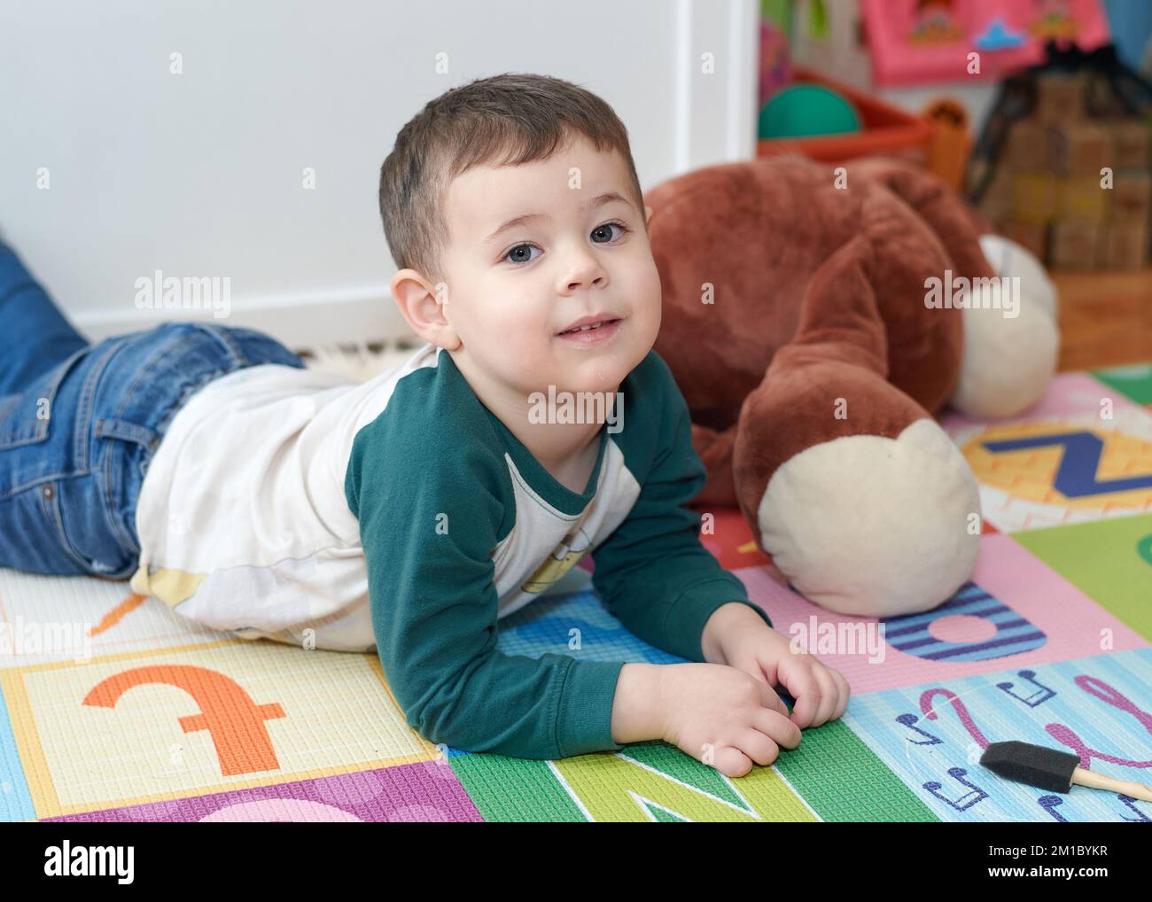 expressive baby boy posing for portraits in his room surrounded by toys ...