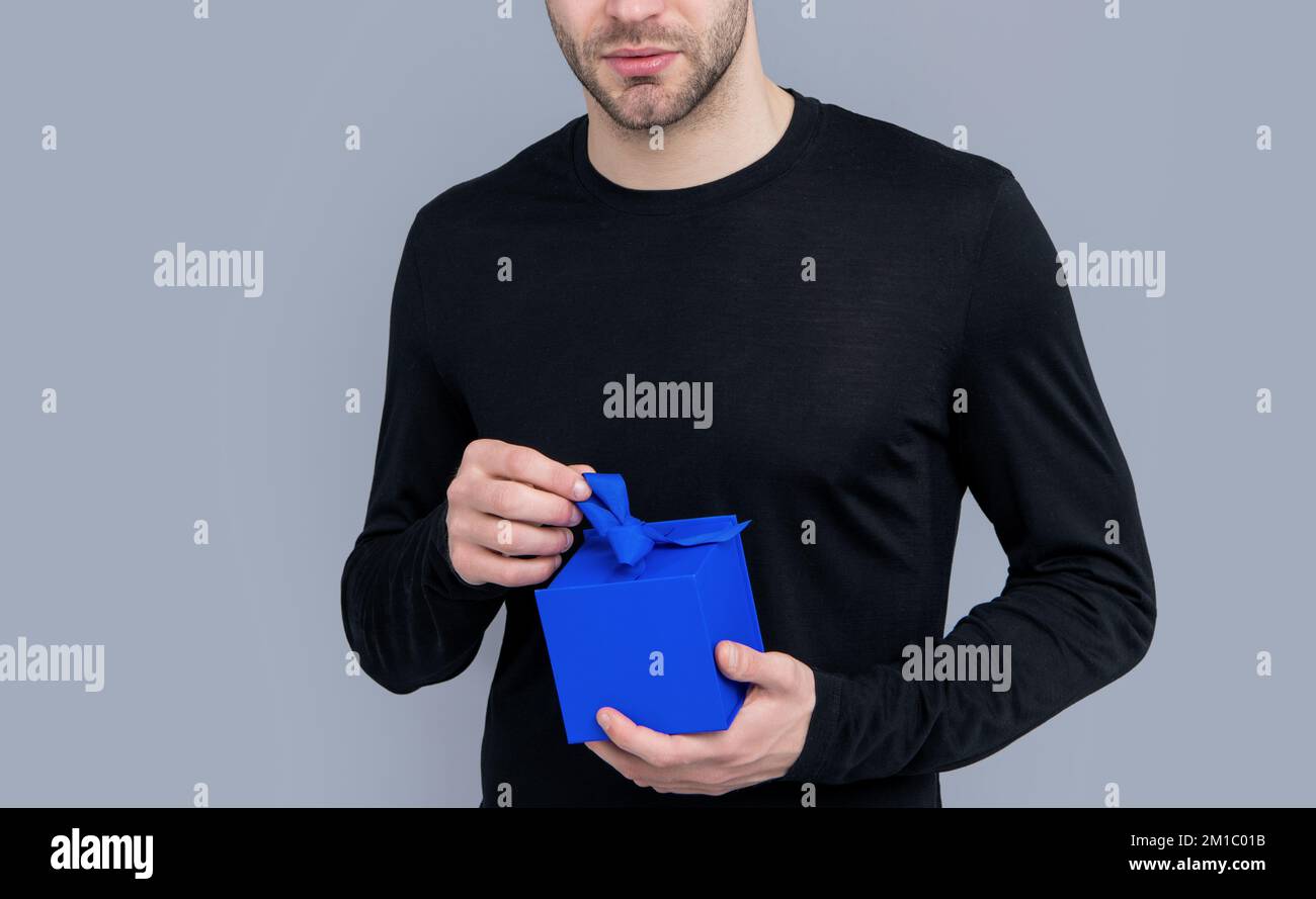 cropped view of man with present box in studio. present for man. box of ...