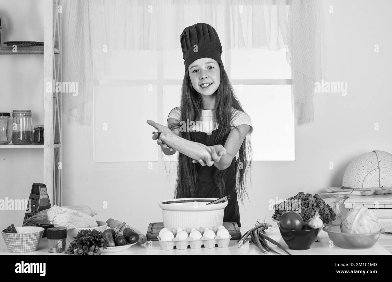 kid cooking food in kitchen. choosing a career. little helper with ...