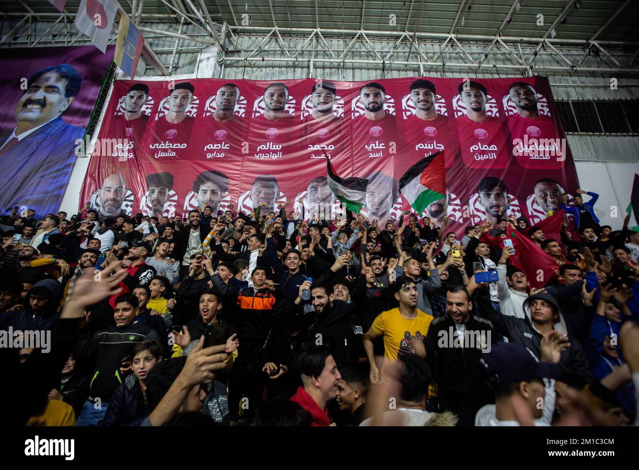 Palestinians react while watch the live broadcast of the FIFA World Cup ...