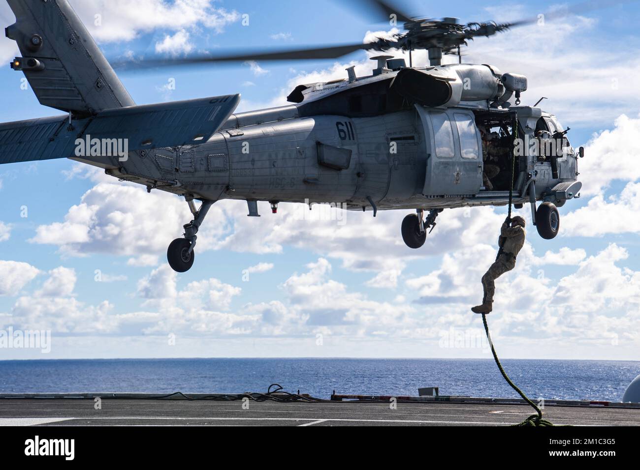 221208-N-XK462-1094 PACIFIC OCEAN (Dec. 8, 2022) A U.S. Navy Sailor fast ropes onto the flight ...