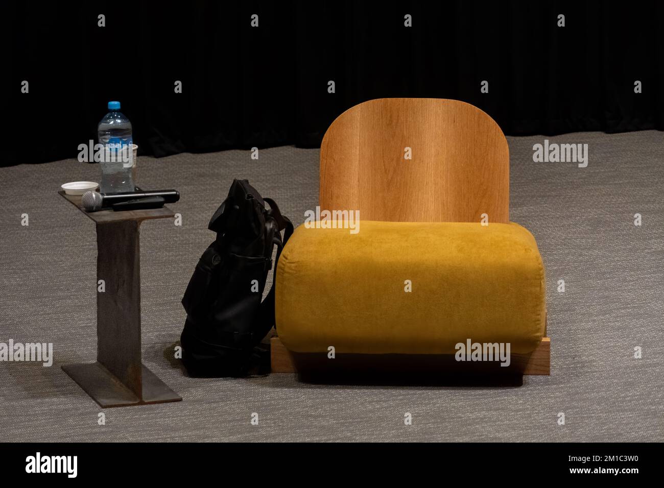 Designer yellow chair next to simple table in living room with work ...