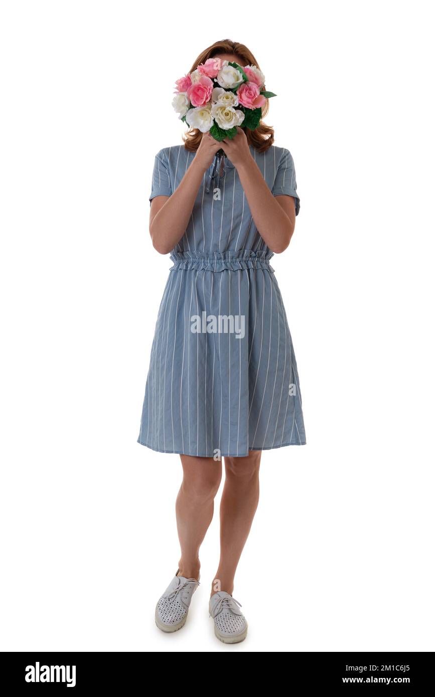 Full-length portrait of caucasian woman in blue dress hiding behind the ...