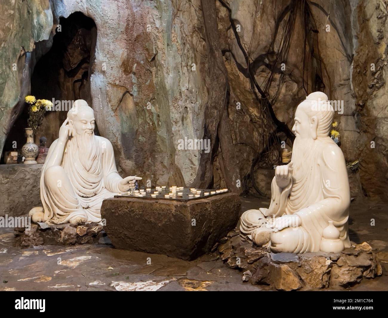Statue of 2 old man playing chess at a cave at Hue Vietnam Stock Photo ...