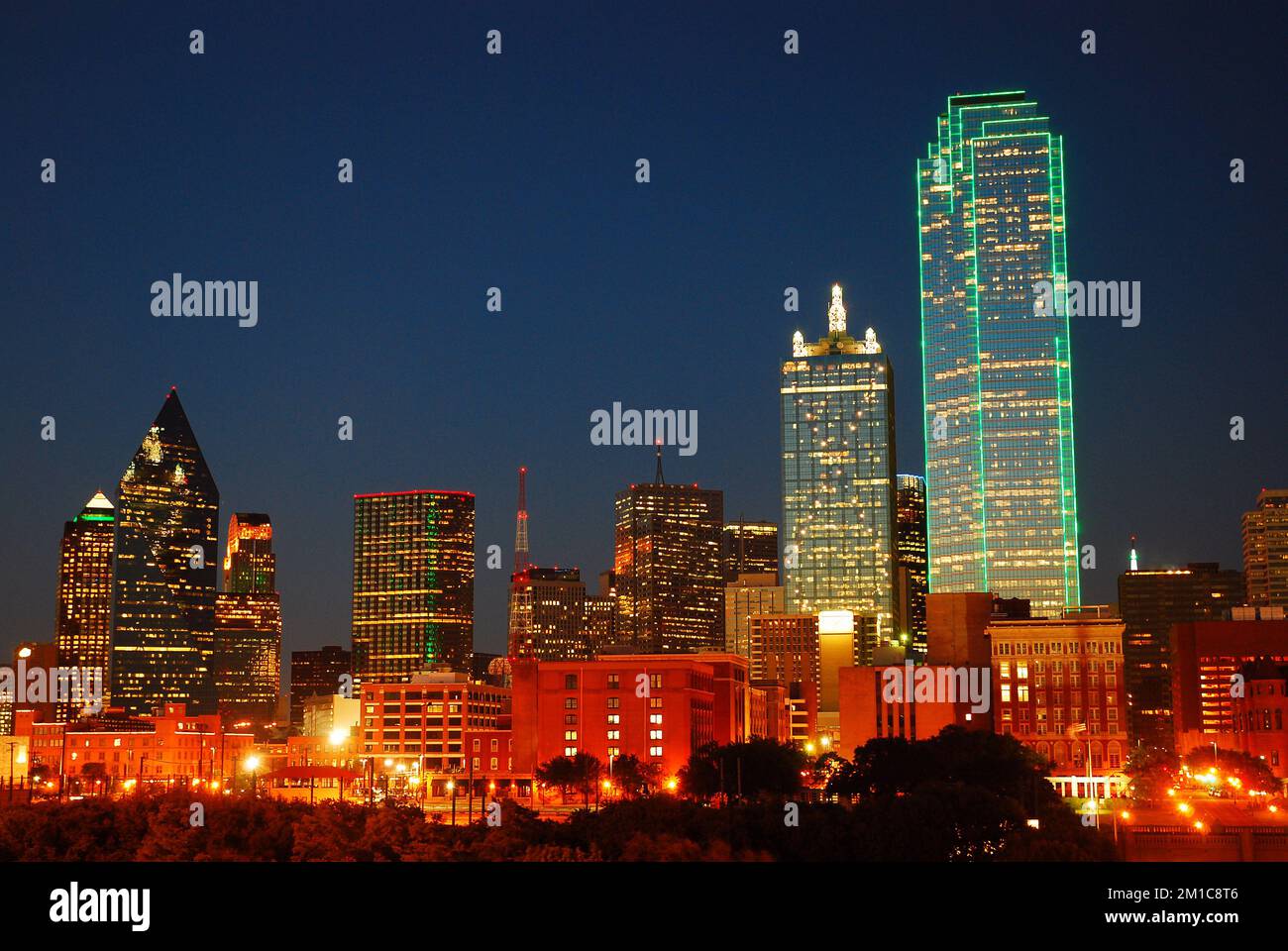 The office buildings of the Dallas Texas Skyline glows against a Dusk ...
