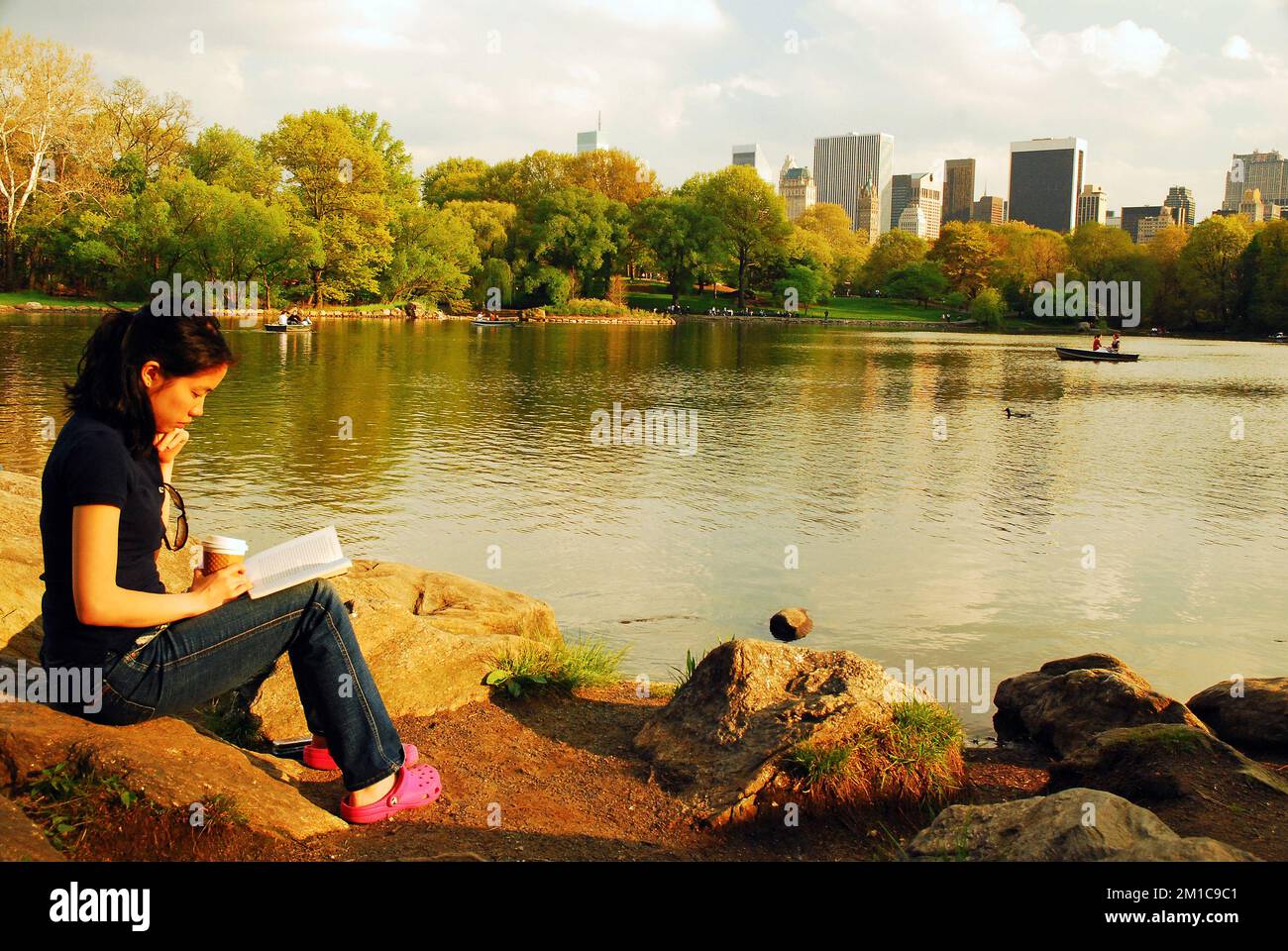 A Young Woman Enjoys Some Quiet Time reading a book in New York's ...