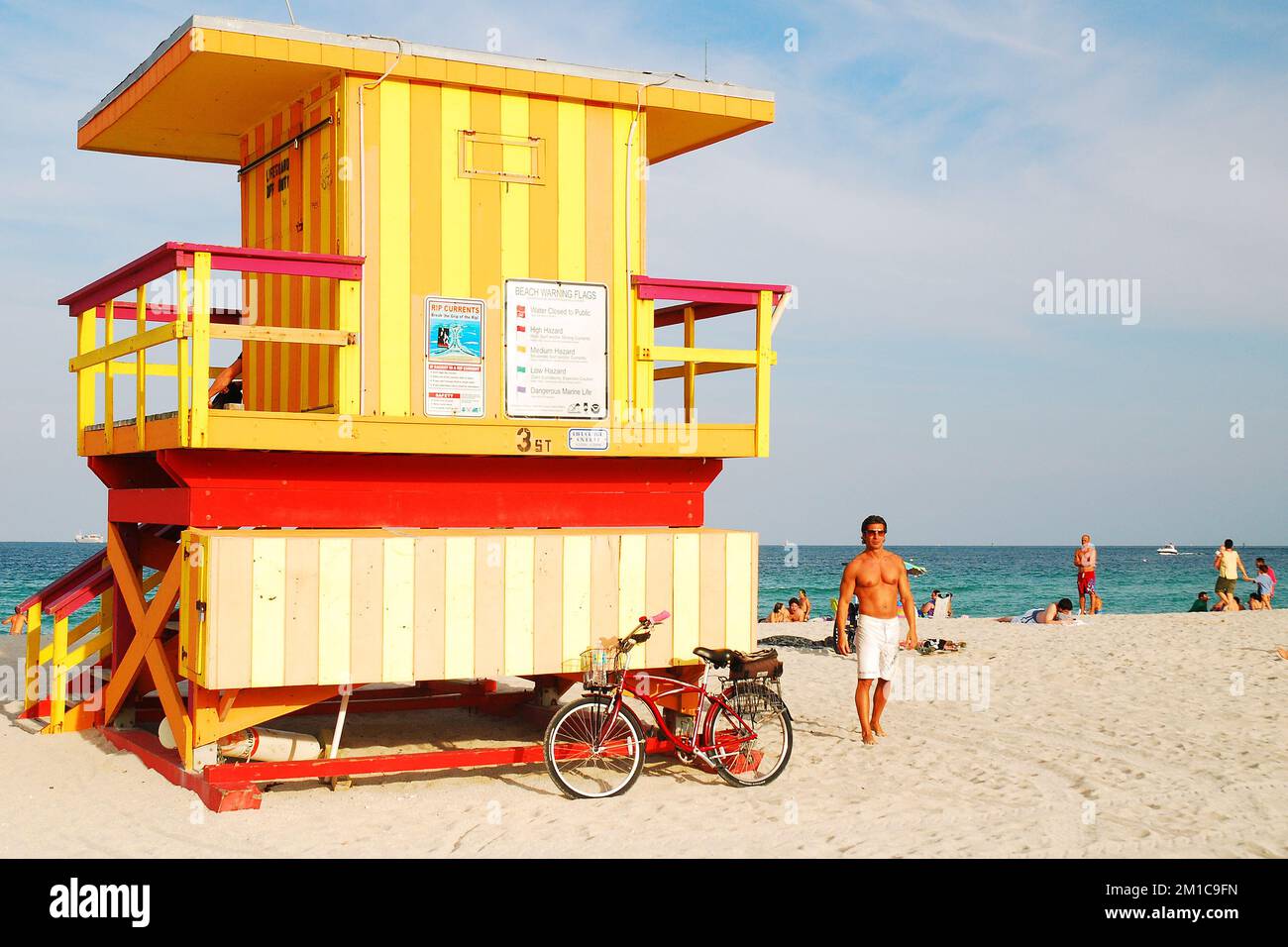 A young adult beachgoer walks past the colorful Art Deco Third Street ...