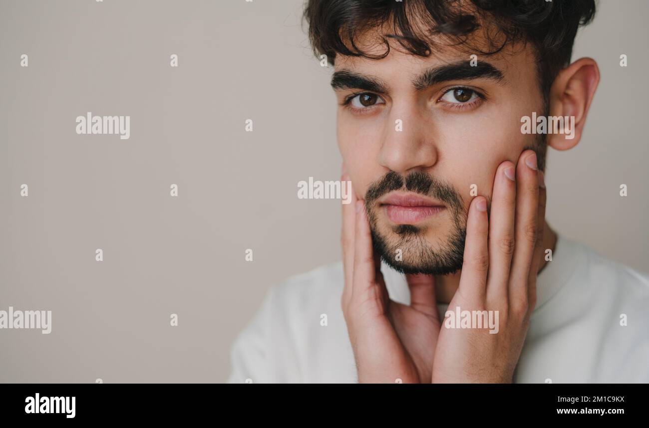 Head shot portrait of a man touching face with hands, massaging perfect ...