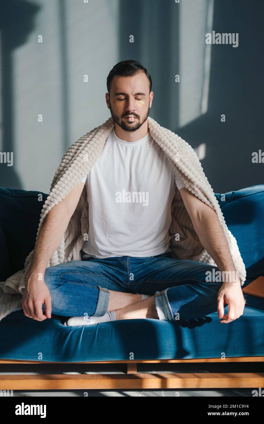 Tranquil calm young man resting with eyes closed enjoying comfort on ...