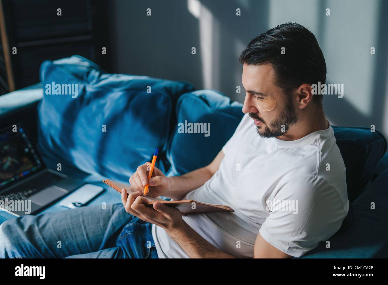Portrait of concentrated man using laptop for remote work sitting on ...