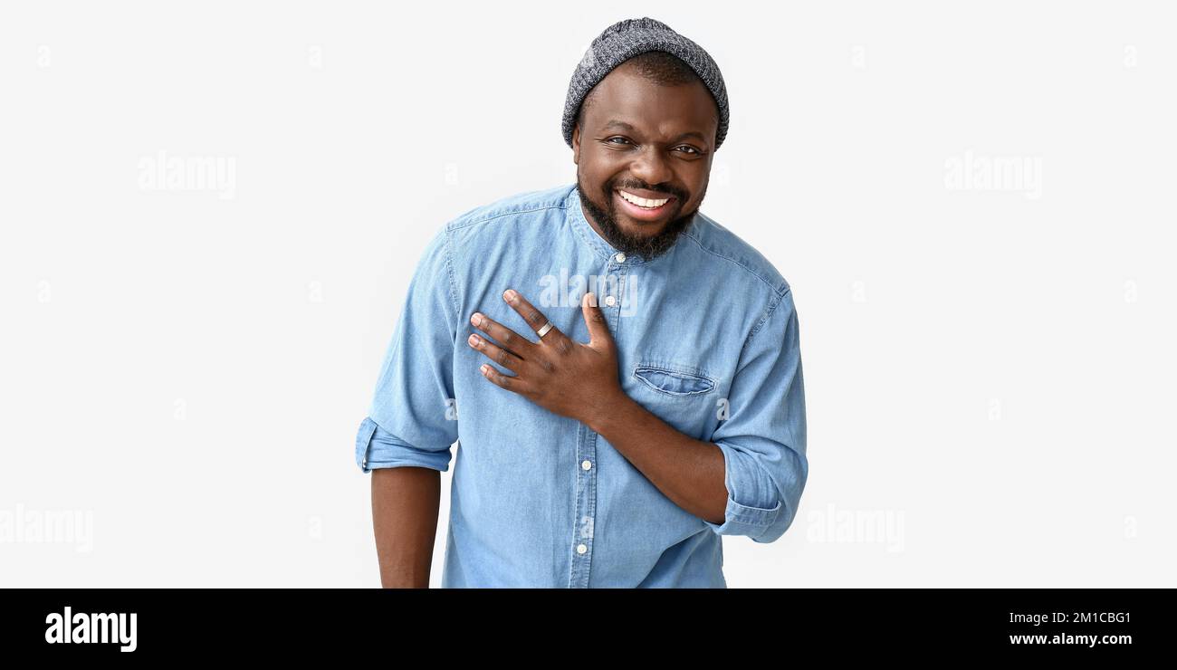 Portrait of happy African-American man on light background Stock Photo ...