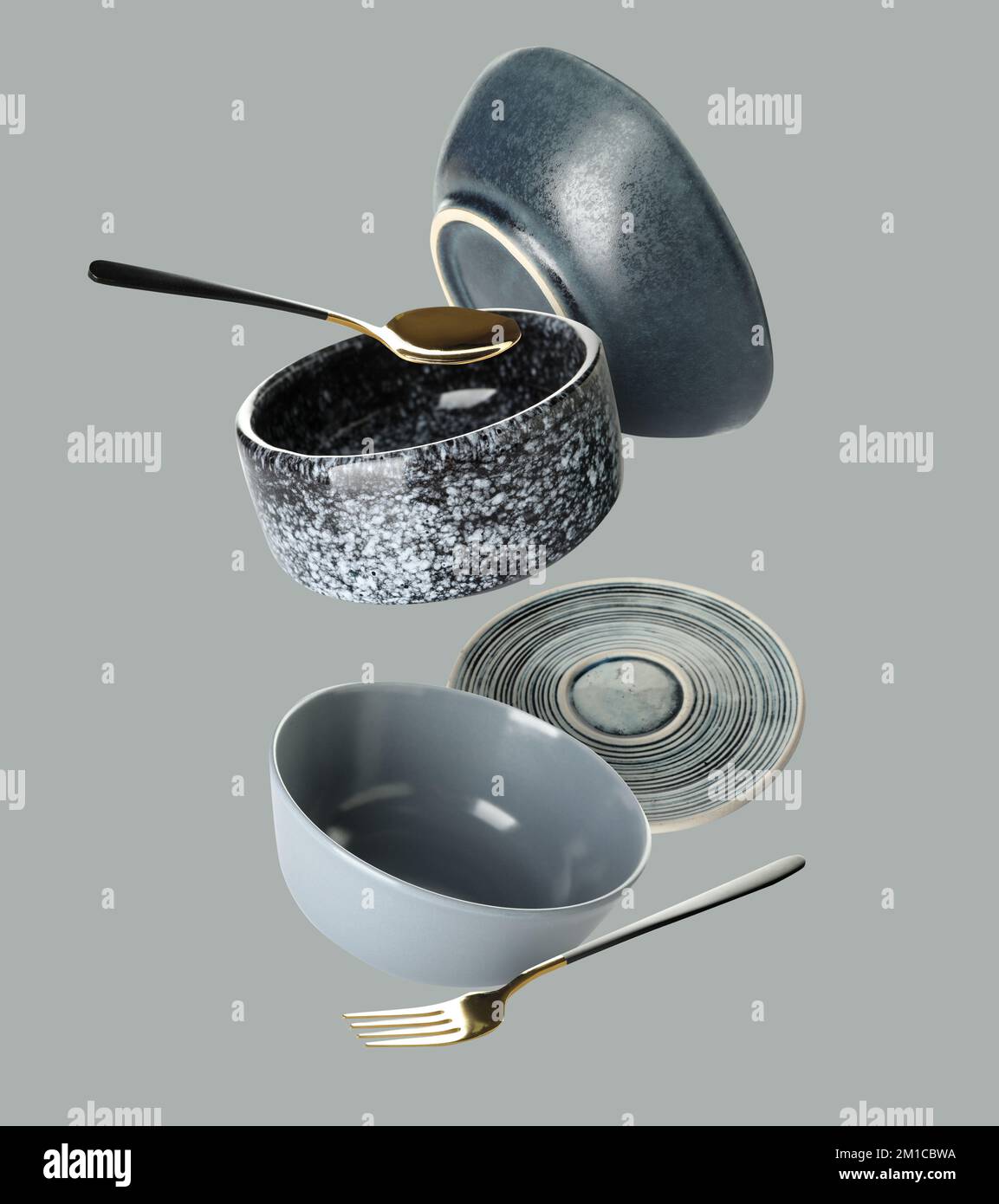 Flying clean dishes and cutlery on grey background Stock Photo - Alamy