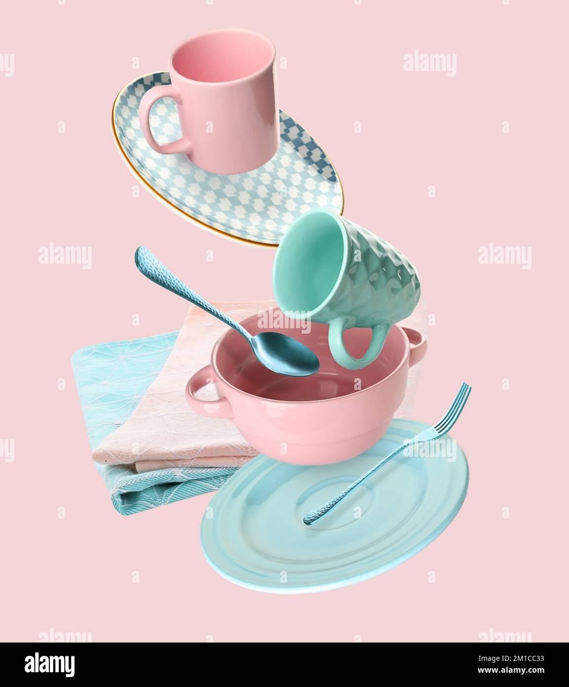 Flying clean dishes, napkins and cutlery on pink background Stock Photo ...