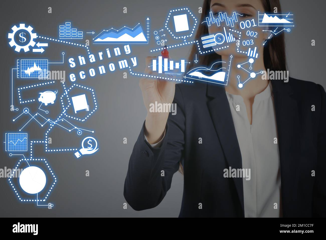 Businesswoman writing on virtual screen against grey background ...