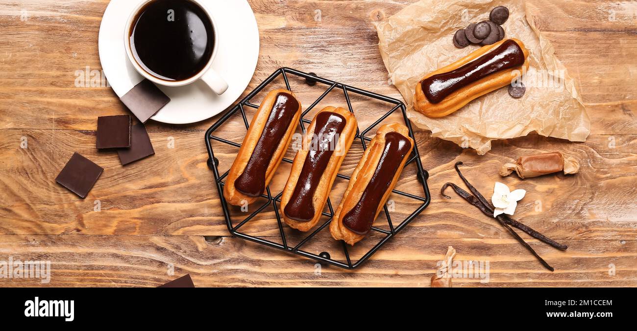 Composition with sweet eclairs and coffee on wooden background, top ...