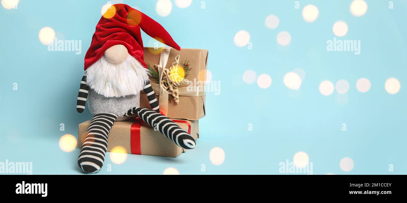 Christmas gnome with gifts on blue background with space for text Stock ...