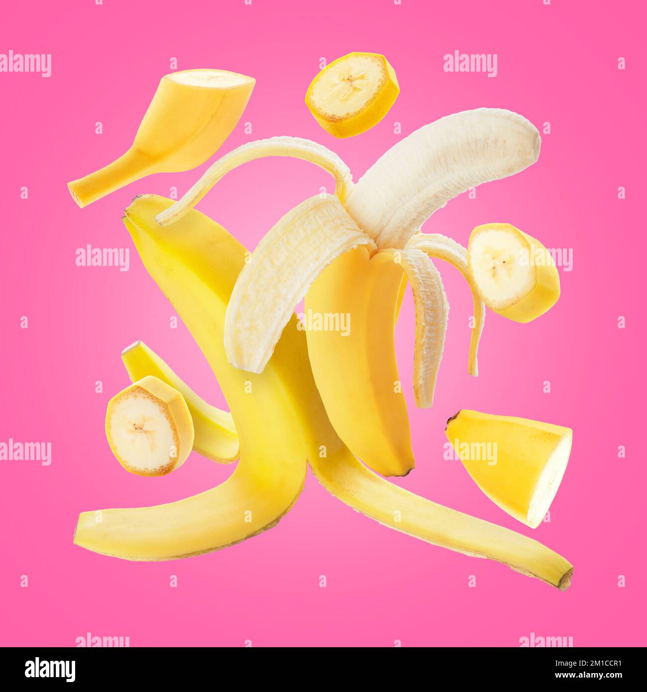 Flying fresh bananas on pink background Stock Photo - Alamy