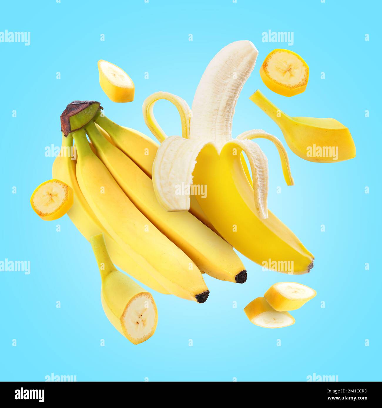 Flying fresh bananas on blue background Stock Photo - Alamy
