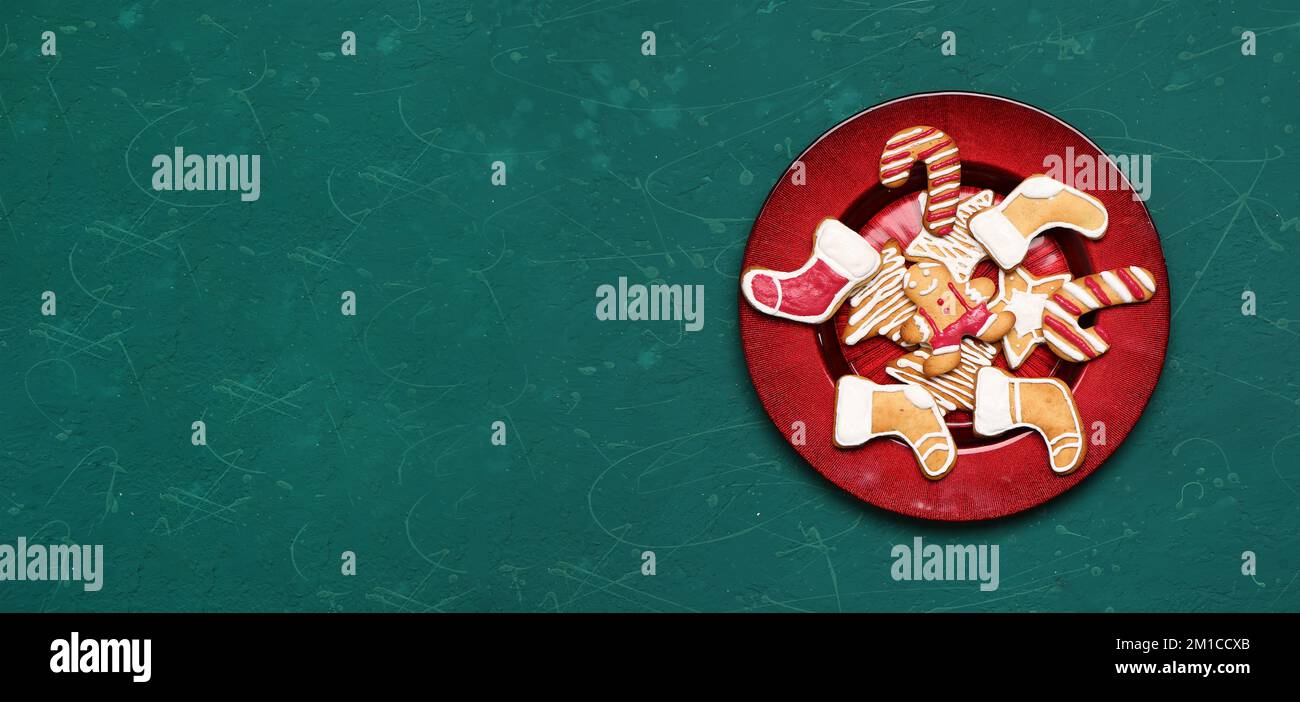 Plate of different Christmas cookies on green background with space for ...