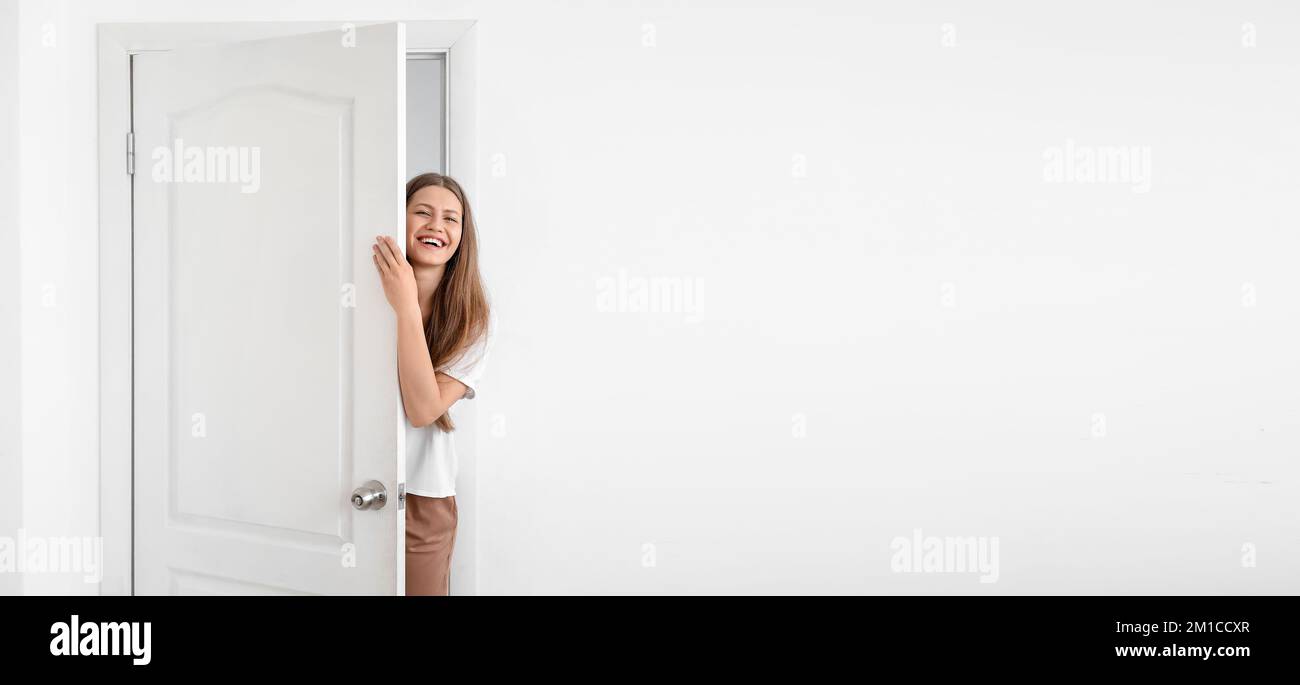 Curious woman standing in doorway. Banner for design Stock Photo - Alamy