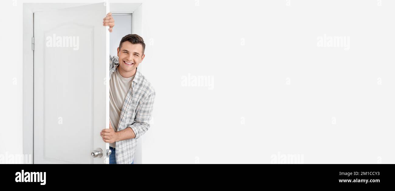 Curious man standing in doorway. Banner for design Stock Photo - Alamy
