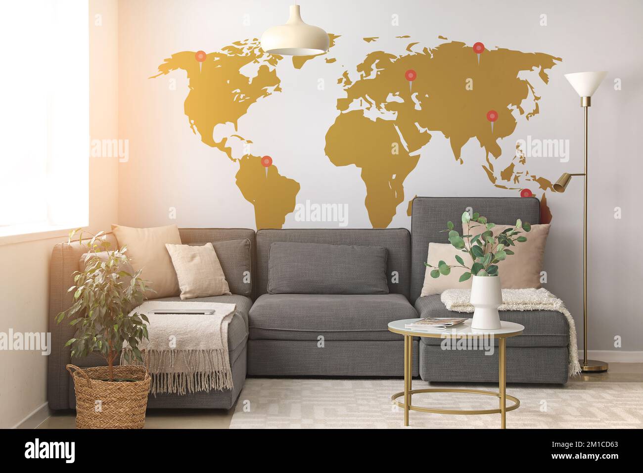 Interior of modern living room with cozy sofa and printed world map on ...