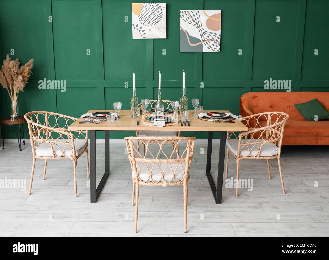 Beautiful table setting with candles in stylish room Stock Photo - Alamy