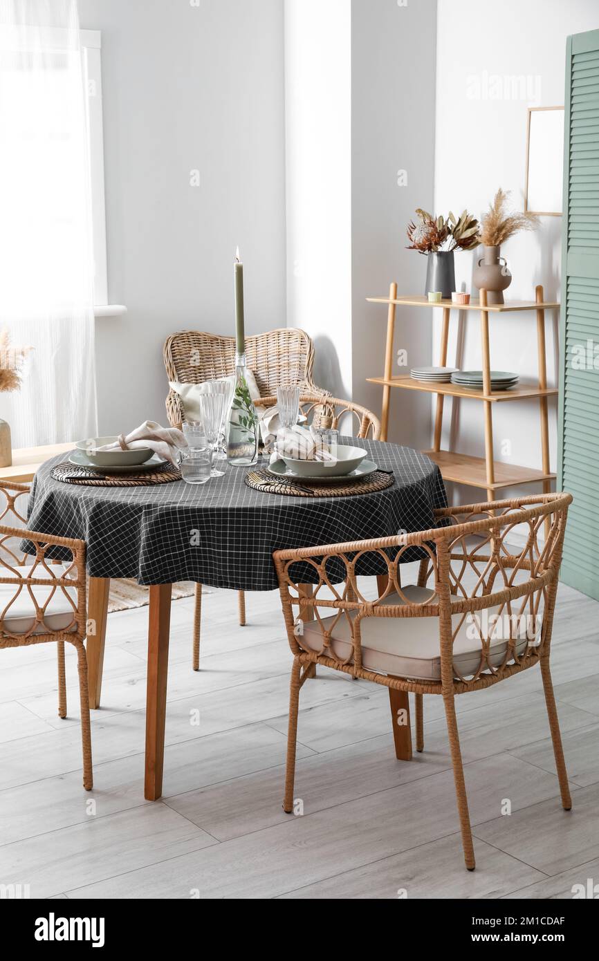 Beautiful table setting with burning candle in stylish room Stock Photo ...