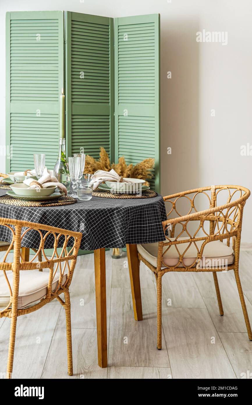 Beautiful table setting with burning candle in stylish room Stock Photo ...