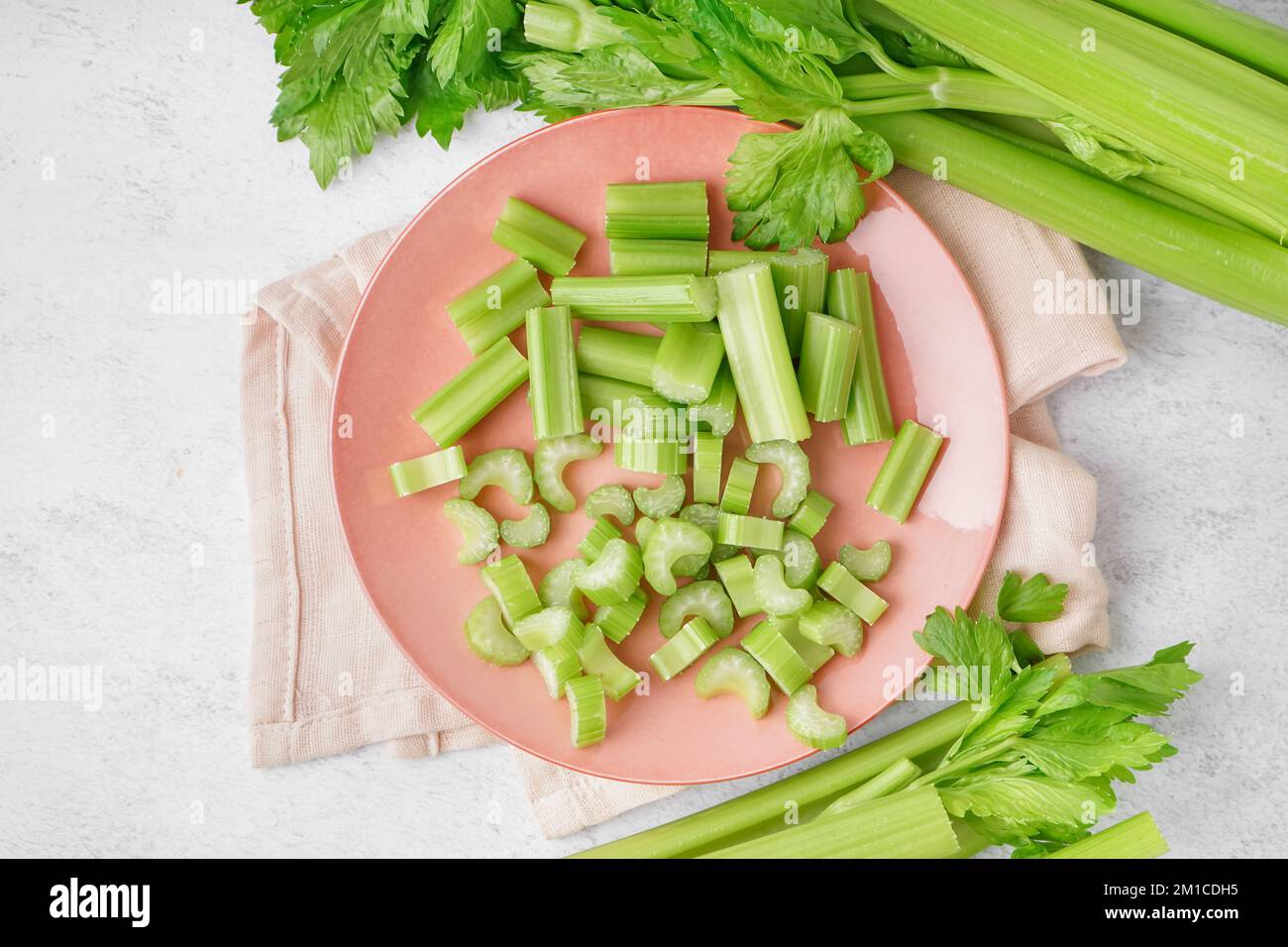 Plate of cut fresh celery on light background Stock Photo - Alamy