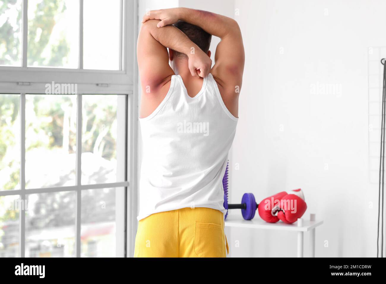 Sporty man with bruises on body training in gym, back view Stock Photo ...