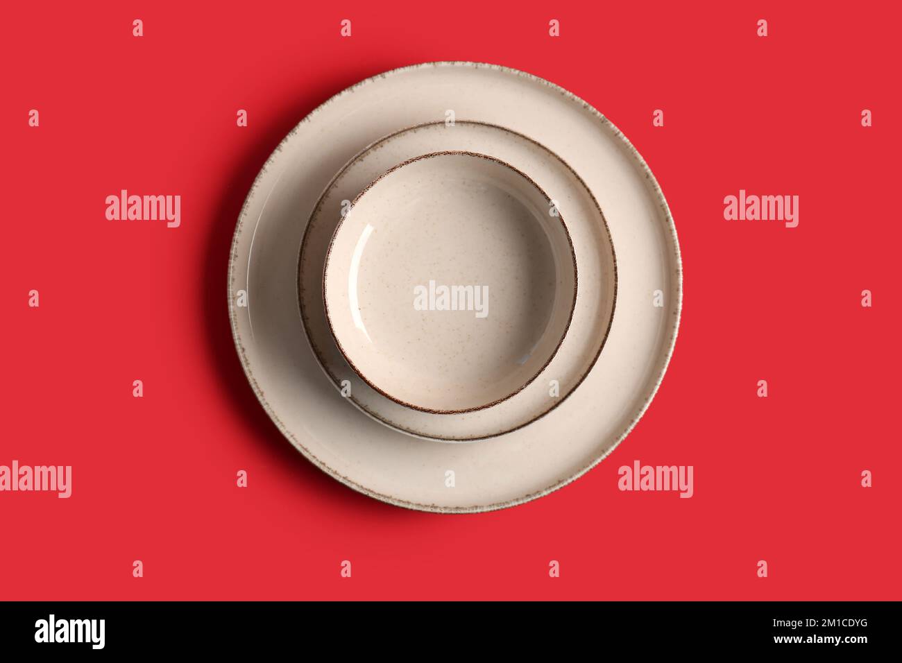 Beautiful plates on red background Stock Photo - Alamy