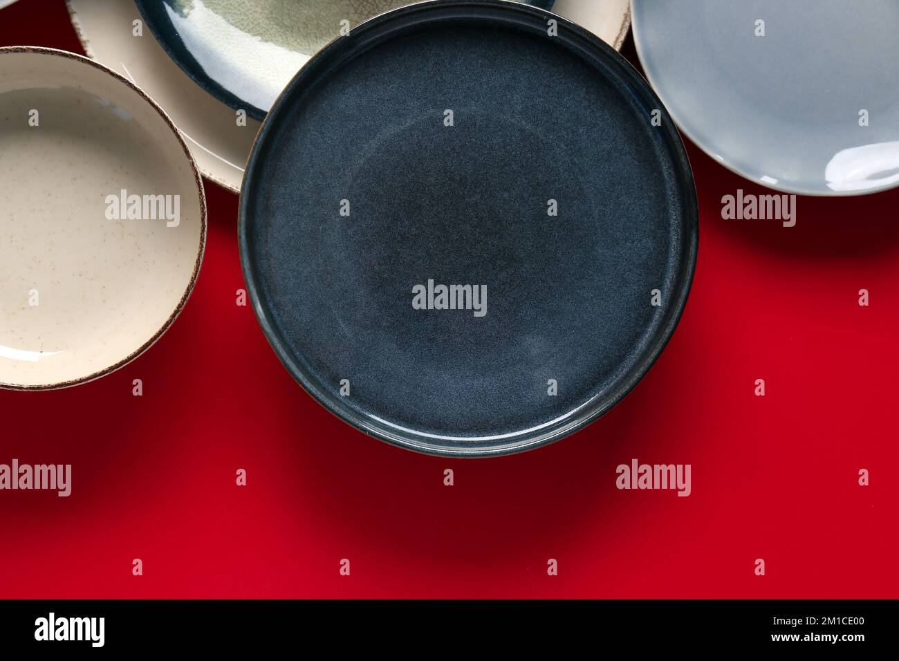 Beautiful plates on red background Stock Photo - Alamy