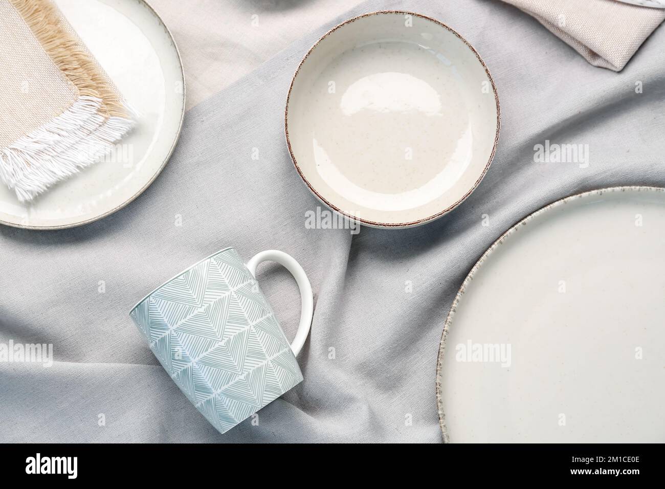 Beautiful table setting on grey cloth Stock Photo - Alamy