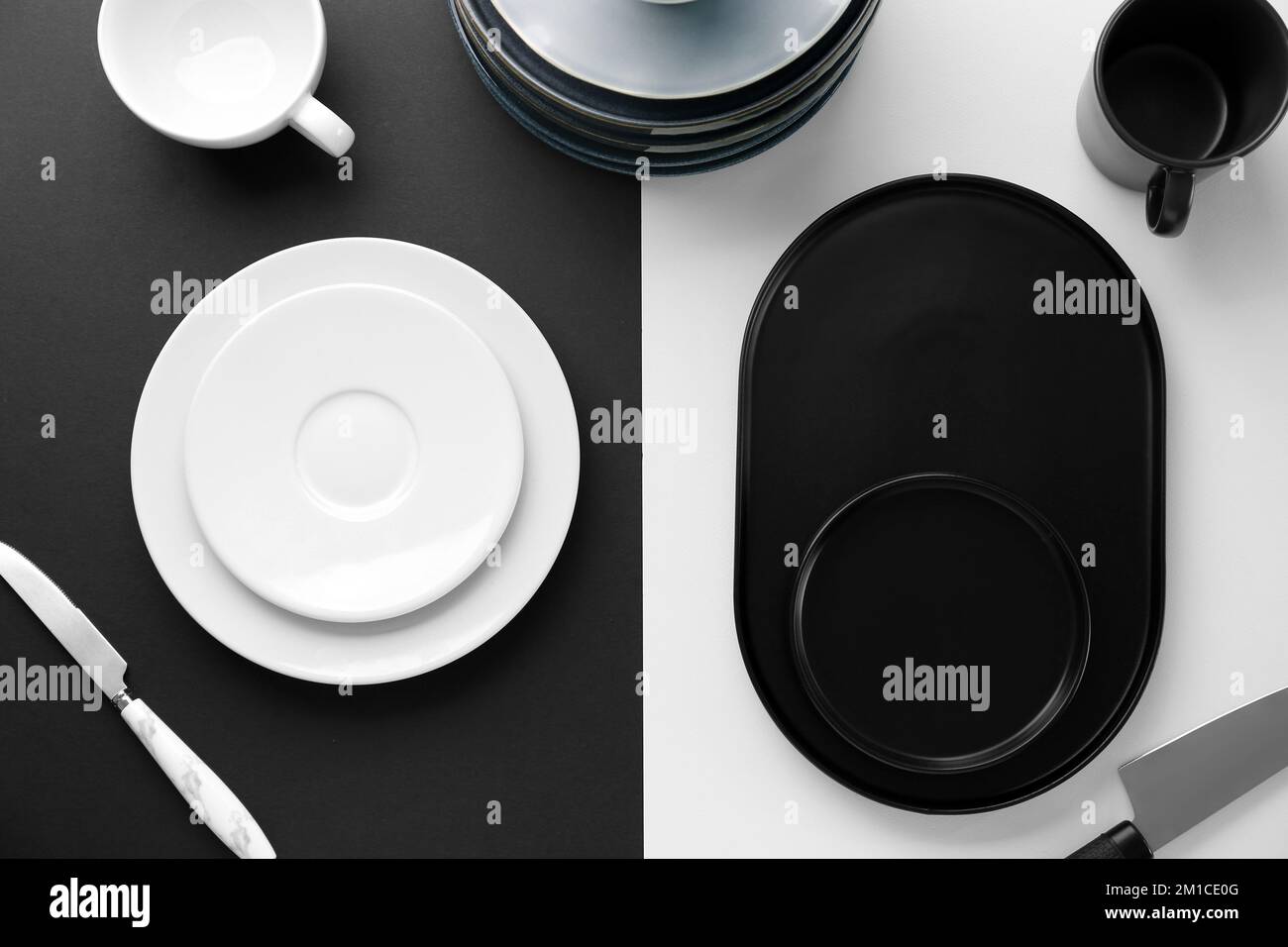 Stylish table setting on black and white background Stock Photo - Alamy