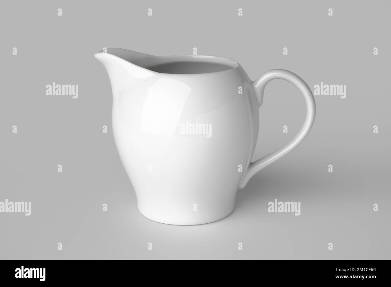Empty pitcher on grey background Stock Photo - Alamy