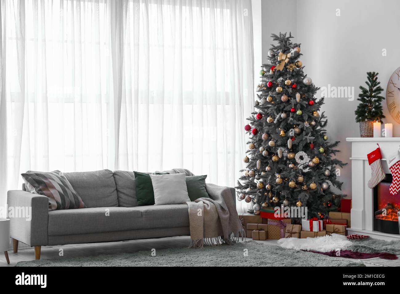Interior of living room with sofa and Christmas trees Stock Photo - Alamy
