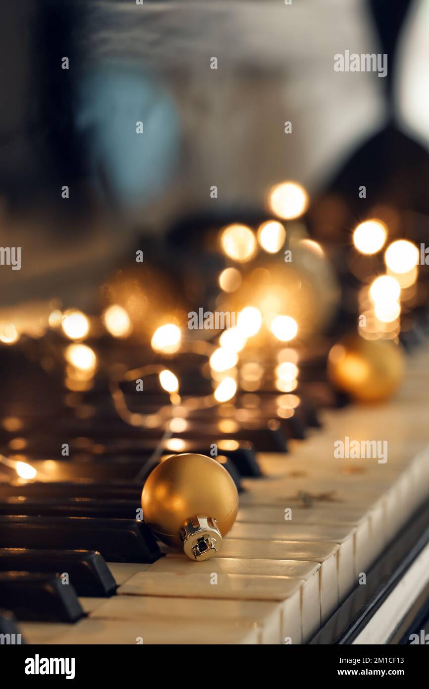 Christmas ball with glowing lights on piano keys, closeup Stock Photo ...