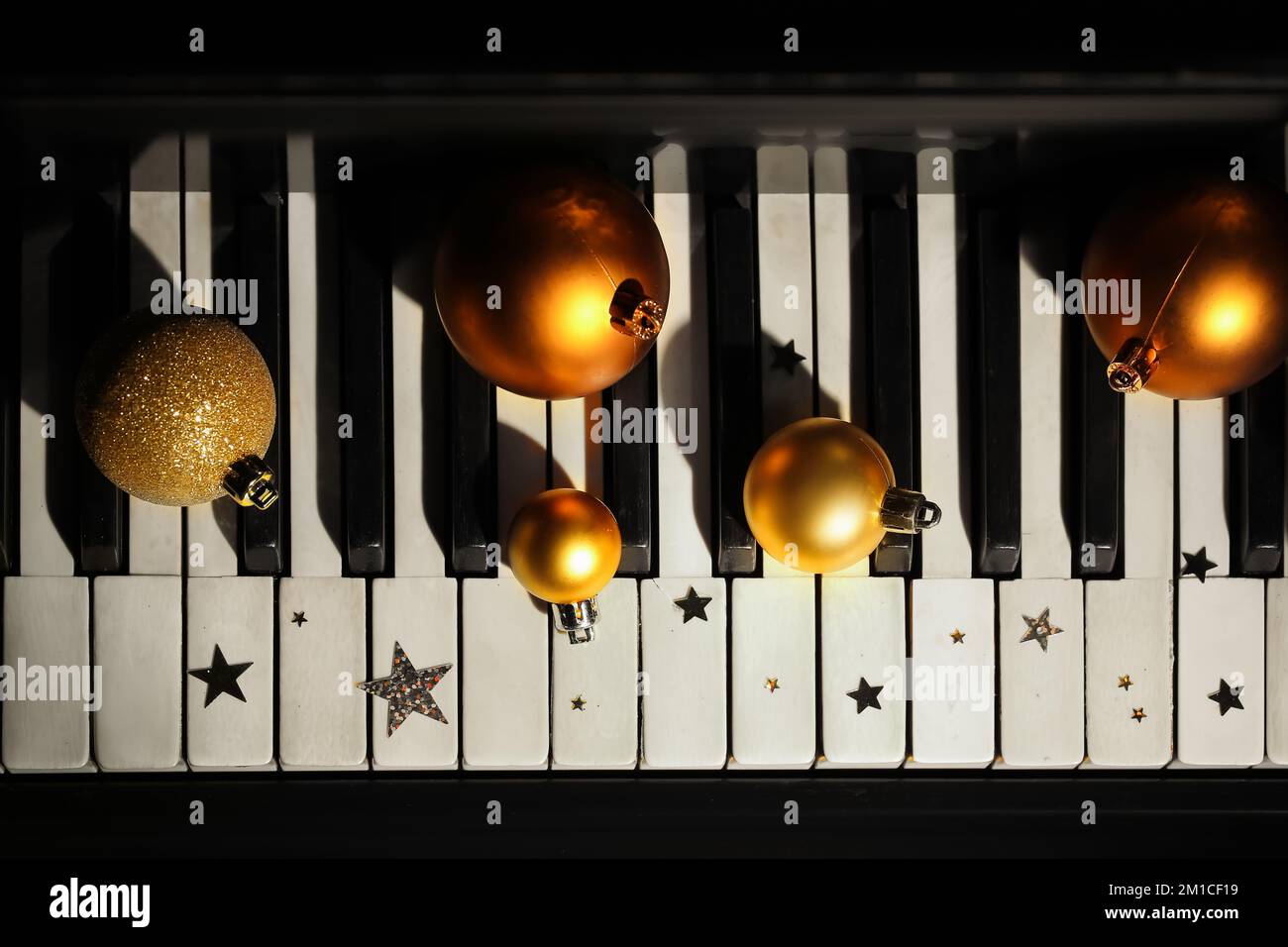 Christmas balls with stars on piano keys at night, closeup Stock Photo ...
