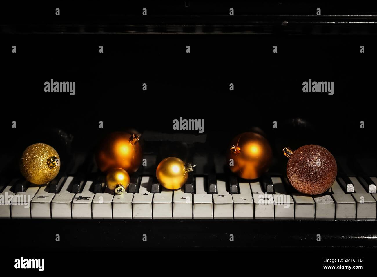 Christmas balls with stars on piano keys at night, closeup Stock Photo ...