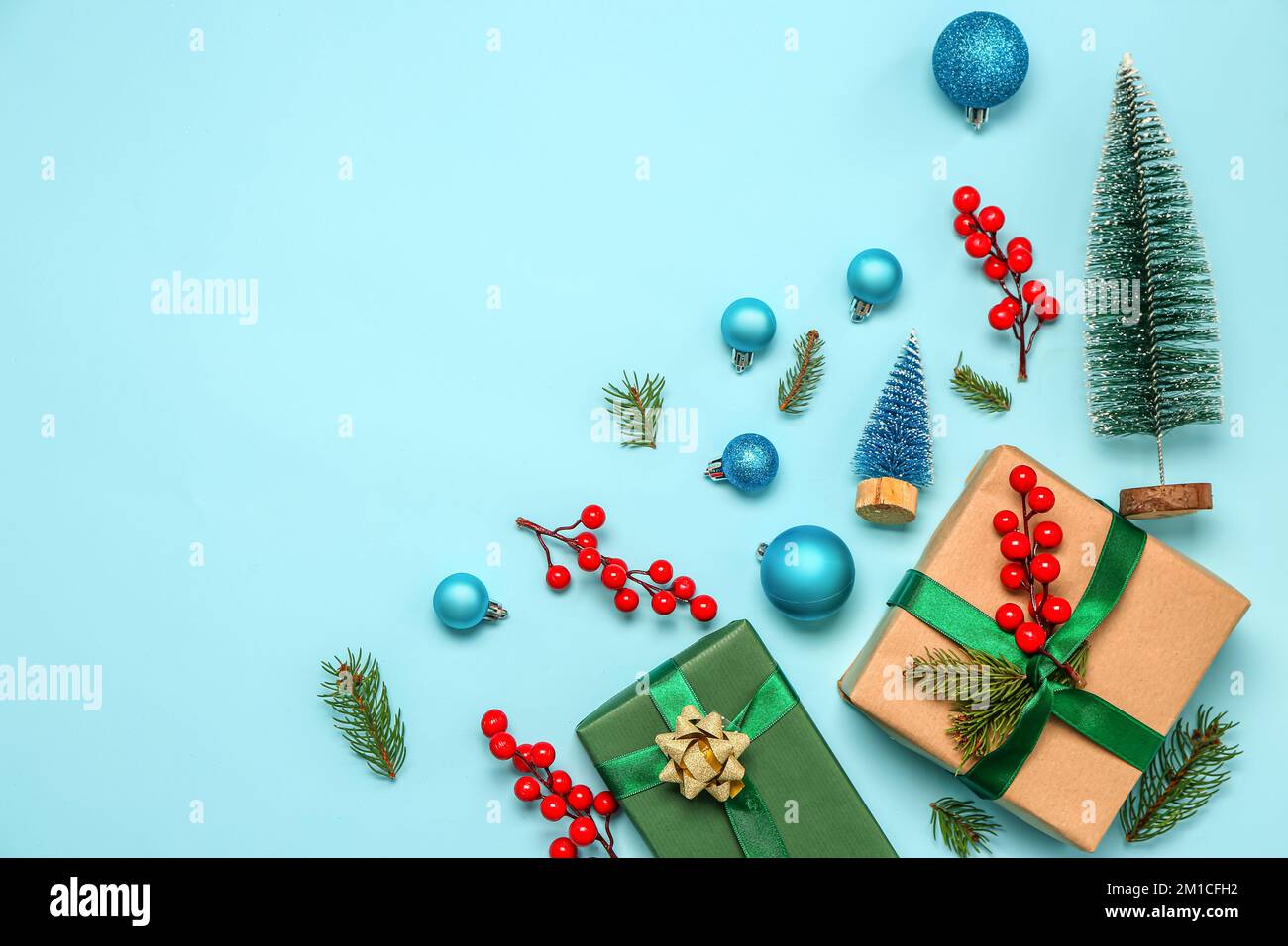 Christmas gift boxes with fir branches and decor on blue background ...