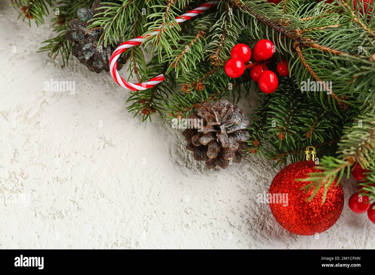 Christmas branches with candy cane, fir cone, cranberry and ball on ...