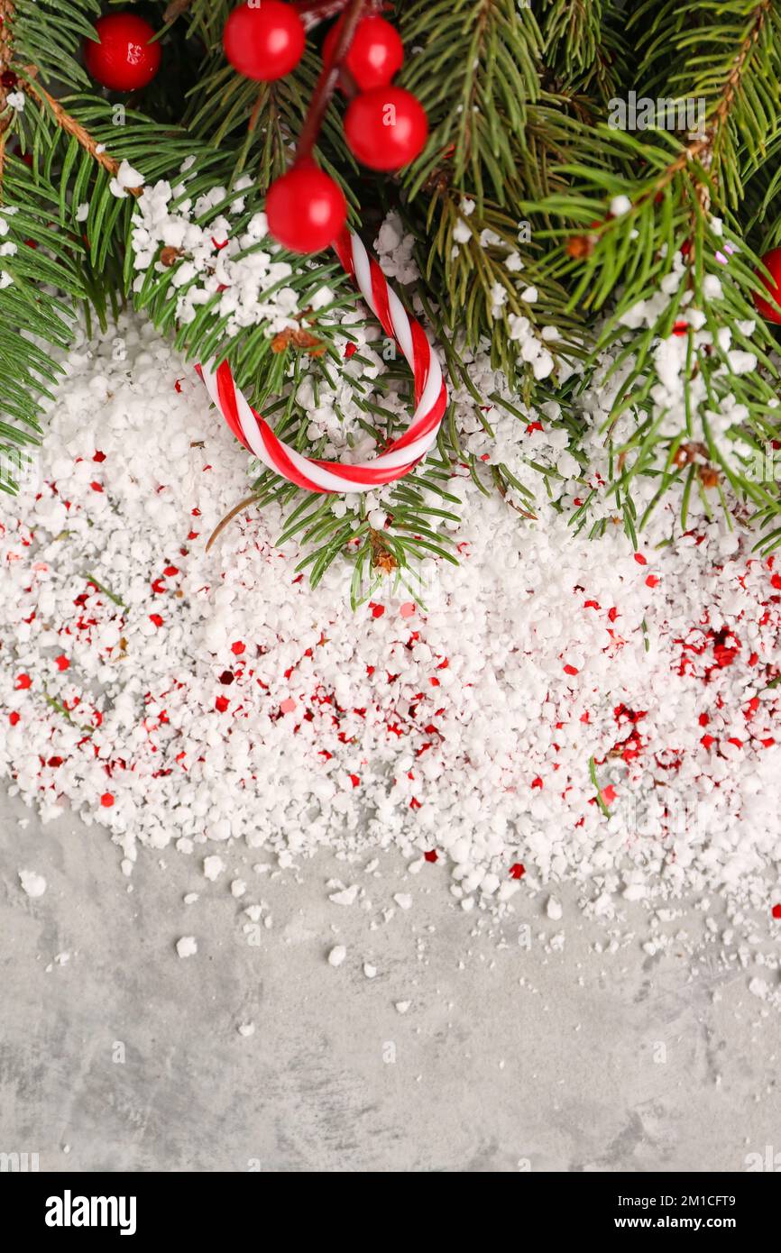 Christmas branches with rowan, candy cane and snow on grunge background ...