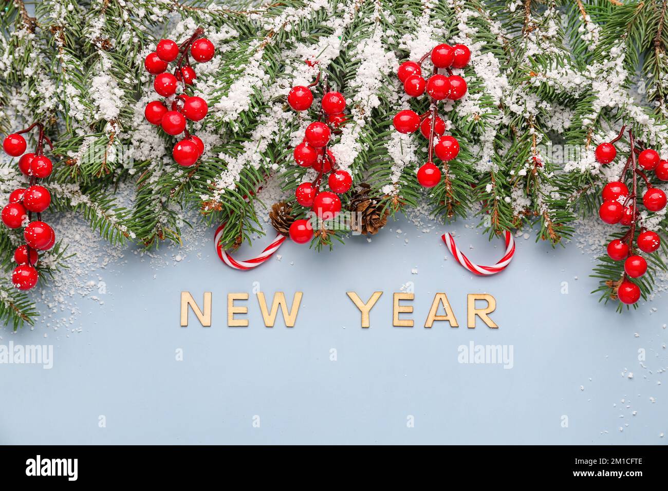 Christmas branches with rowan, snow, candy canes and text NEW YEAR on ...