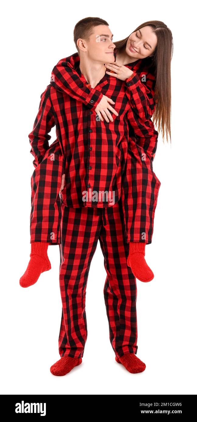 Young couple in checkered pajamas on white background Stock Photo - Alamy