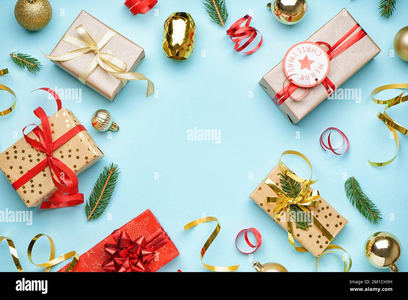 Frame made of gifts, Christmas balls and fir branches on blue ...